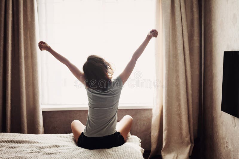 Woman Stretching in Bed after Waking Up, Back View Stock Photo - Image ...