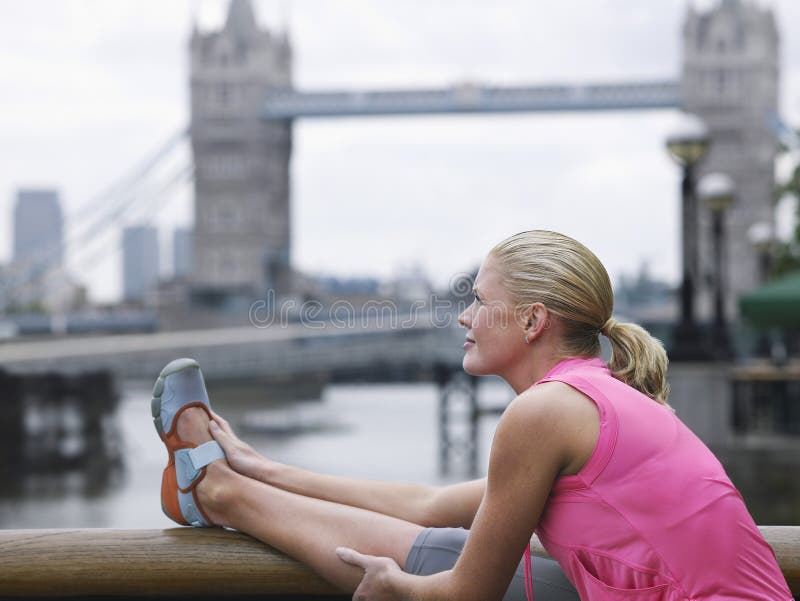 Woman Stretching in Front of Tower Bridge, England, London Stock Photo ...
