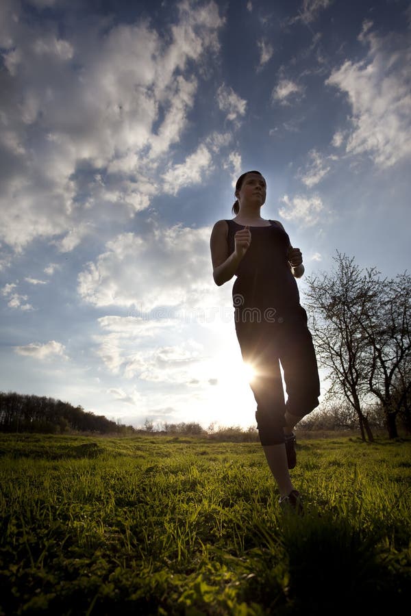 Woman Stretching Out on the Field Stock Image - Image of jogging ...
