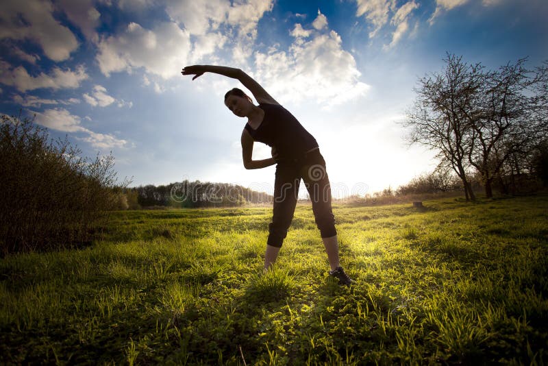 Woman Stretching Out on the Field Stock Image - Image of journey ...