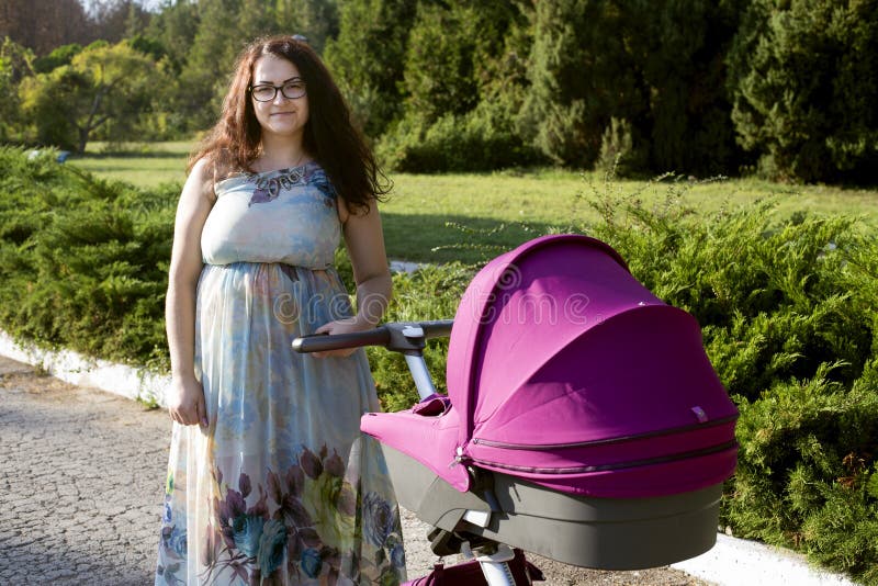 Woman with stroller stock photo. Image of baby, offspring - 79385148