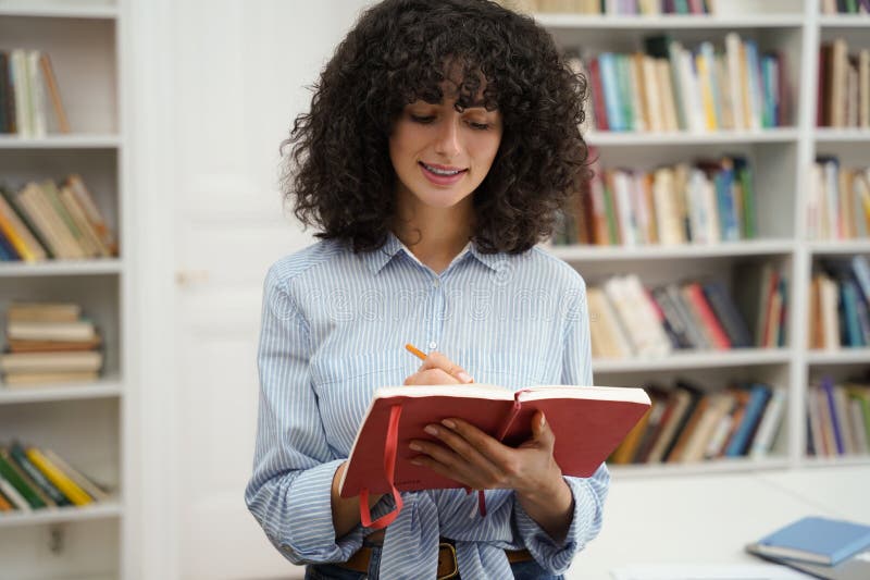 Woman Student Writing in Her Organizer Preparing for Classes in ...