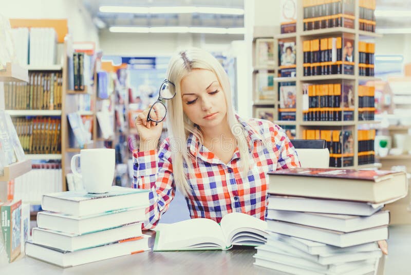 Woman studying in library stock photo. Image of bookshelf - 62228724