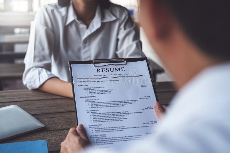 Woman Submits Job Application, Interviewer Reading a Resume Stock Photo ...
