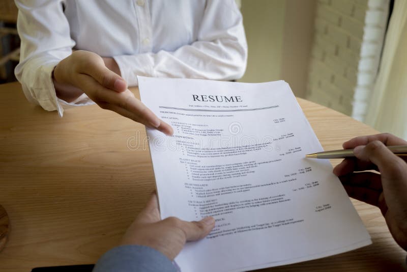 Woman Submits Job Application, Interviewer Reading a Resume. Stock ...