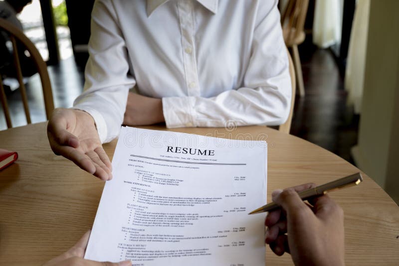 Woman Submits Job Application, Interviewer Reading a Resume. Stock ...