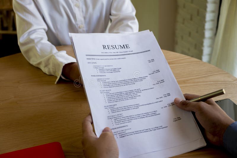 Woman Submits Job Application, Interviewer Reading a Resume. Stock ...