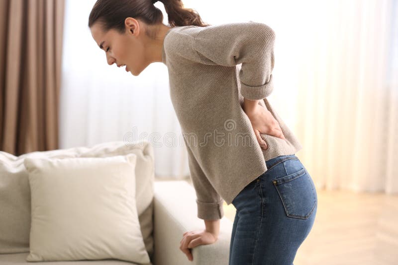 Woman Suffering from Back Pain at Home. Bad Posture Problem Stock Image ...