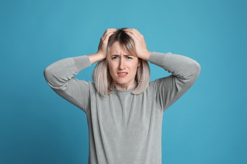 Woman Suffering from Headache on Light Blue Background Stock Image ...
