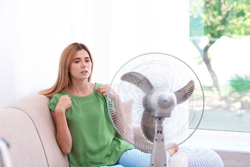 Woman Suffering from Heat in Front of Fan Stock Photo - Image of ...