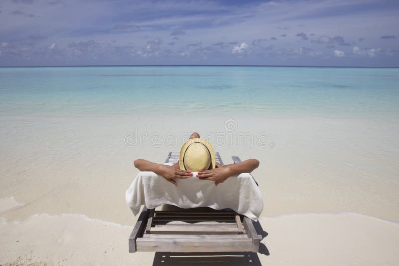 Woman Sunbathing on Beach stock photo. Image of recreational - 26141896