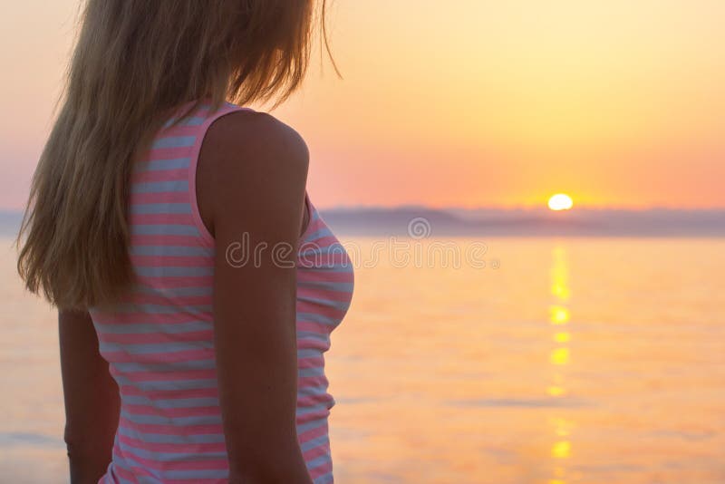 Woman Looking At Sunset Picture. Image: 109889296