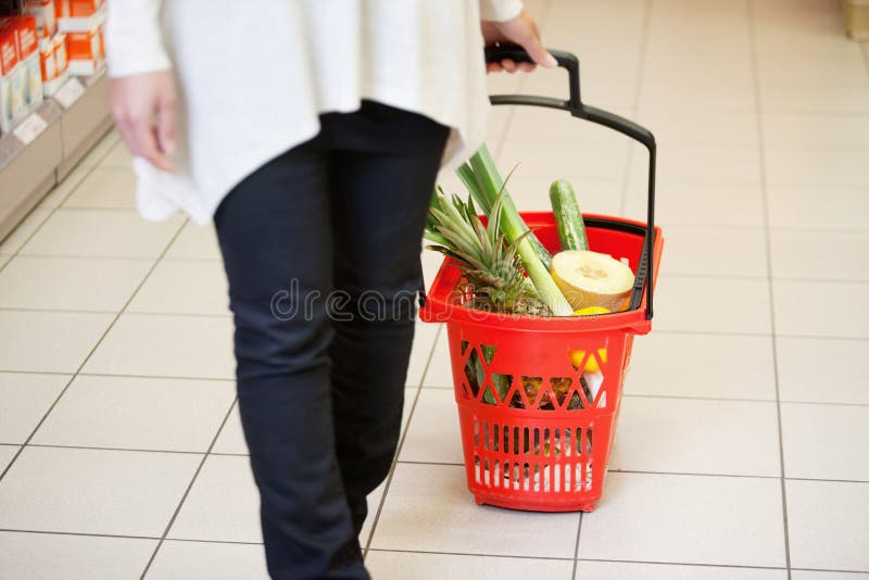 Woman in Supermarket Pulling Basket Stock Image - Image of product ...