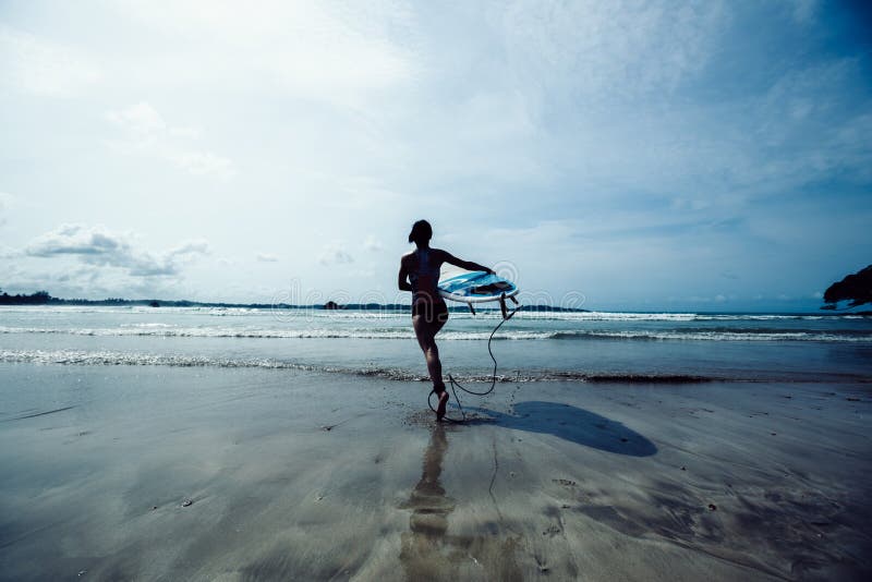 Woman Surfer with Surfboard Stock Photo - Image of silhouette, seaside ...