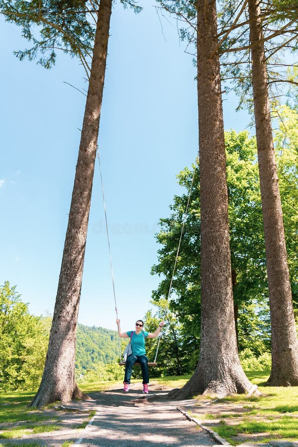 Woman Swing between the Trees Stock Image - Image of laying, nature ...