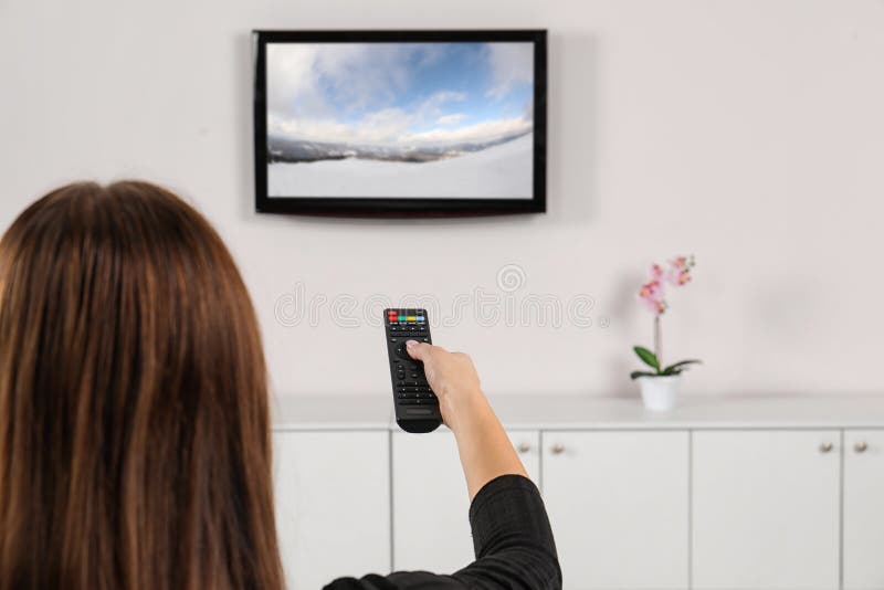 Woman Switching Channels on TV Set with Remote Control Stock Photo ...