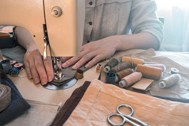 A Woman Tailor Sews on a Sewing Machine. Side View Stock Image - Image ...