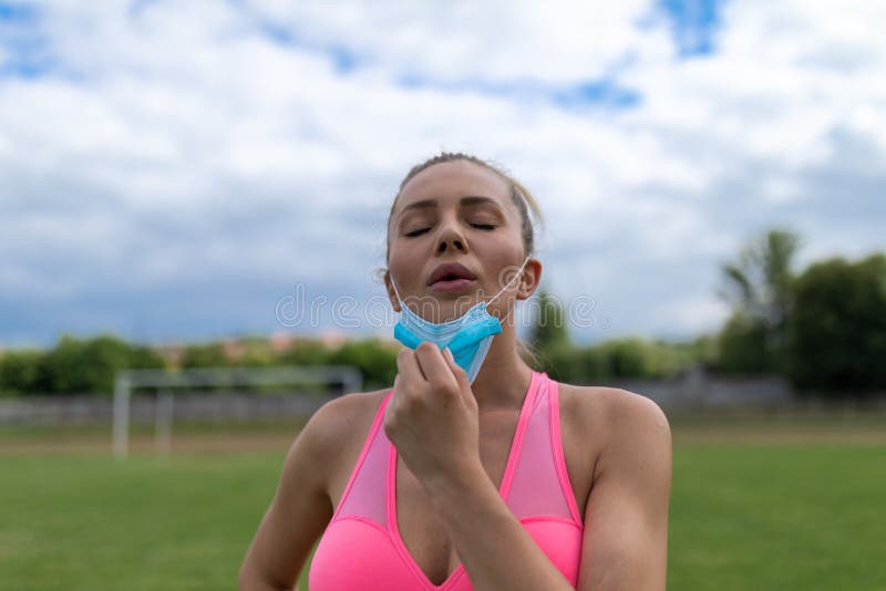 Woman Takes Off Medical Facemask After Outdoor Training Or Running