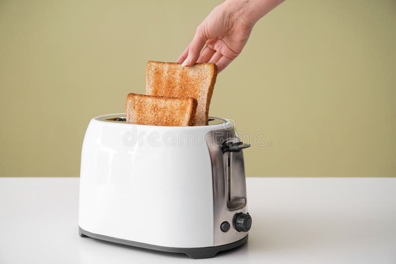 Woman Taking Bread Slice from Toaster on Table Stock Image - Image of ...