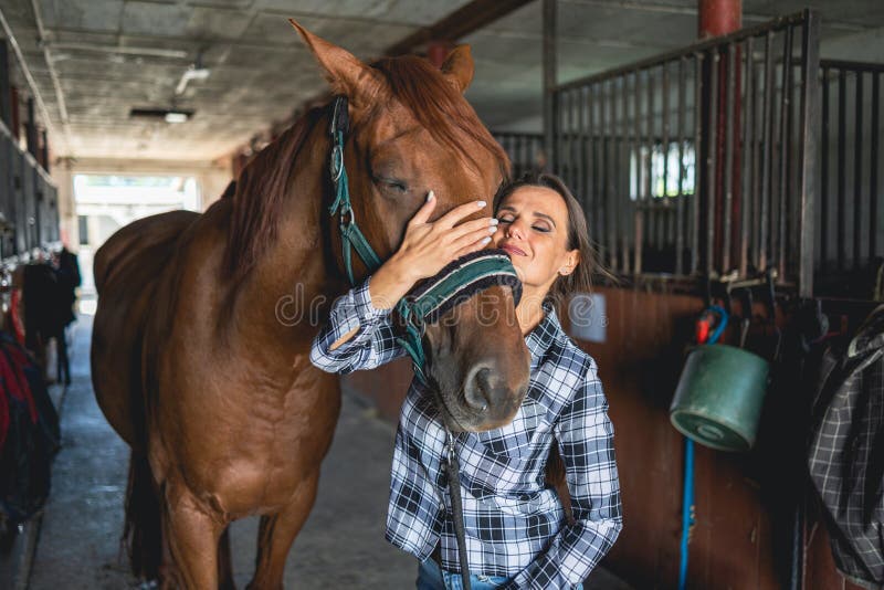 Woman Taking Care of Her Horse in Stable Stock Photo - Image of bridle ...