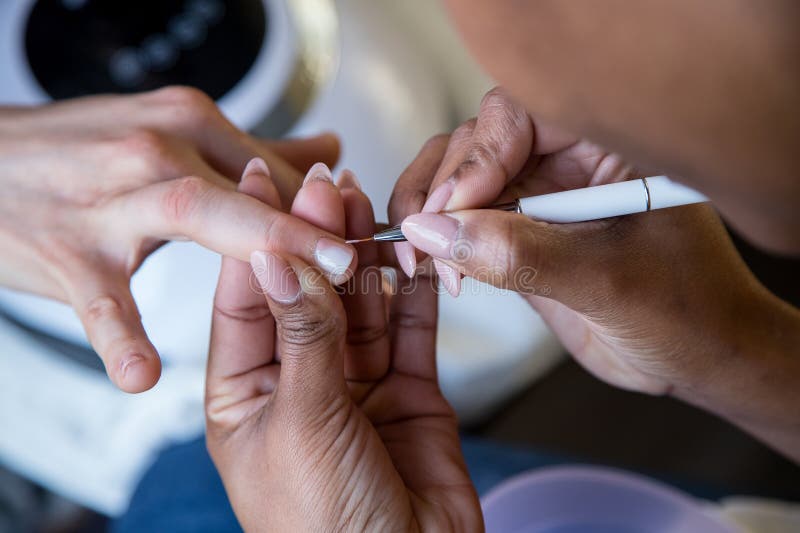 Woman Taking Care of Her Nails with a Manicure Service. Hands of a ...