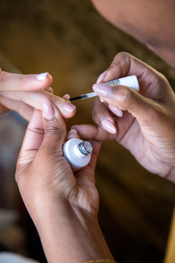 Woman Taking Care of Her Nails with a Manicure Service. Hands of a ...