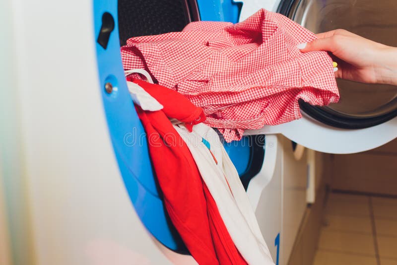 Woman Taking Color Clothes from Washing Machine. Stock Image - Image of ...