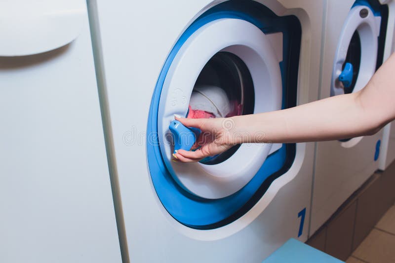 Woman Taking Color Clothes from Washing Machine. Stock Photo - Image of ...