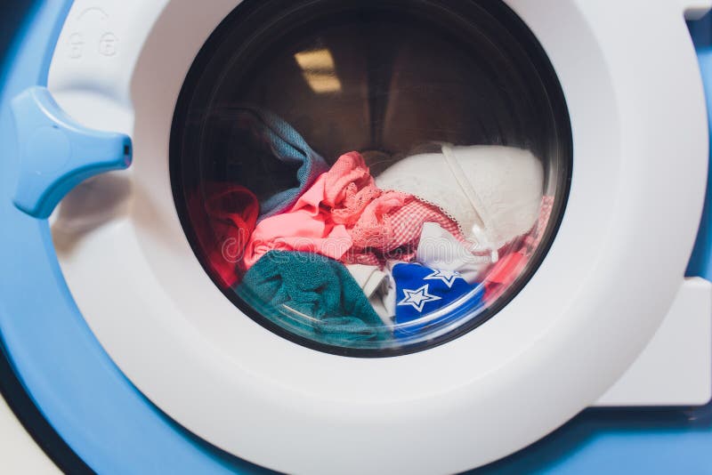 Woman Taking Color Clothes from Washing Machine. Stock Photo - Image of ...