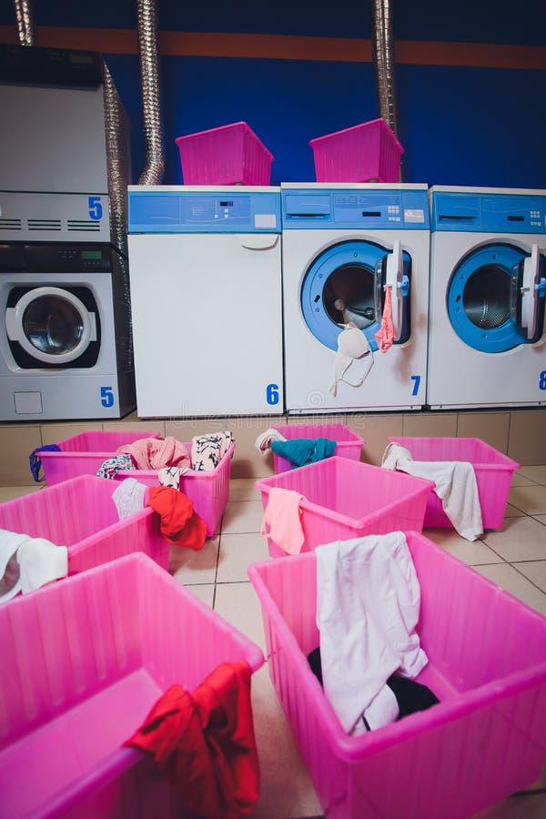 Woman Taking Color Clothes from Washing Machine. Stock Image - Image of ...