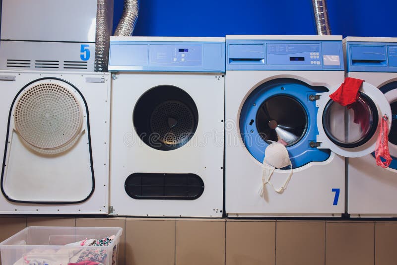 Woman Taking Color Clothes from Washing Machine. Stock Image - Image of ...