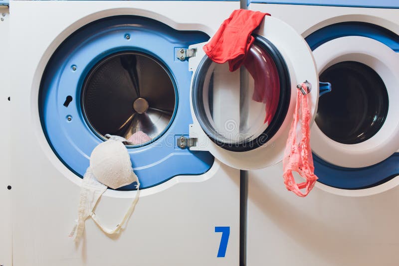 Woman Taking Color Clothes from Washing Machine. Stock Photo - Image of ...