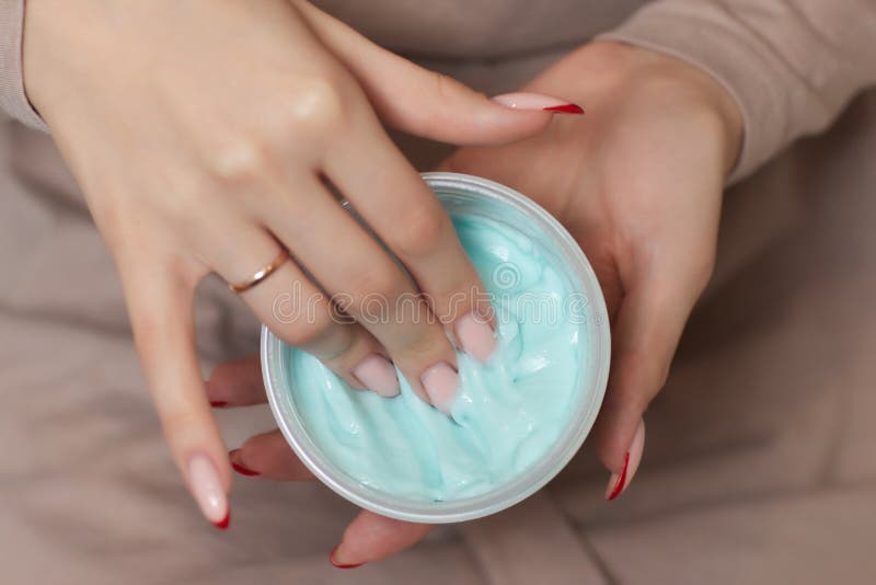 A Woman is Taking Cream in a Pot. Stock Photo - Image of hygiene ...