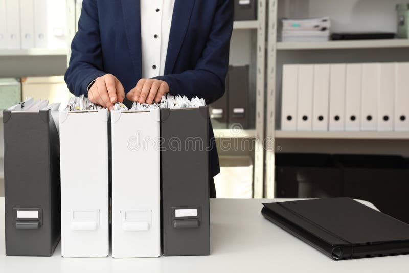 Woman Taking Documents from Folder in Archive, Closeup Stock Photo ...