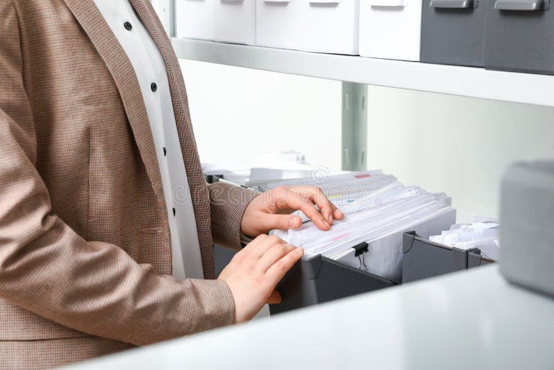 Woman Taking Documents from Folder in Archive Stock Photo - Image of ...