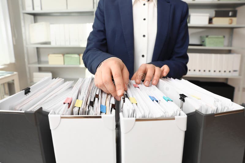 Woman Taking Documents from Folder in Archive Stock Photo - Image of ...
