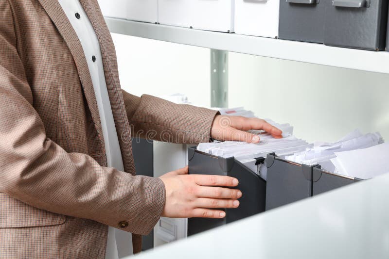 Woman Taking Documents from Folder in Archive Stock Photo - Image of ...