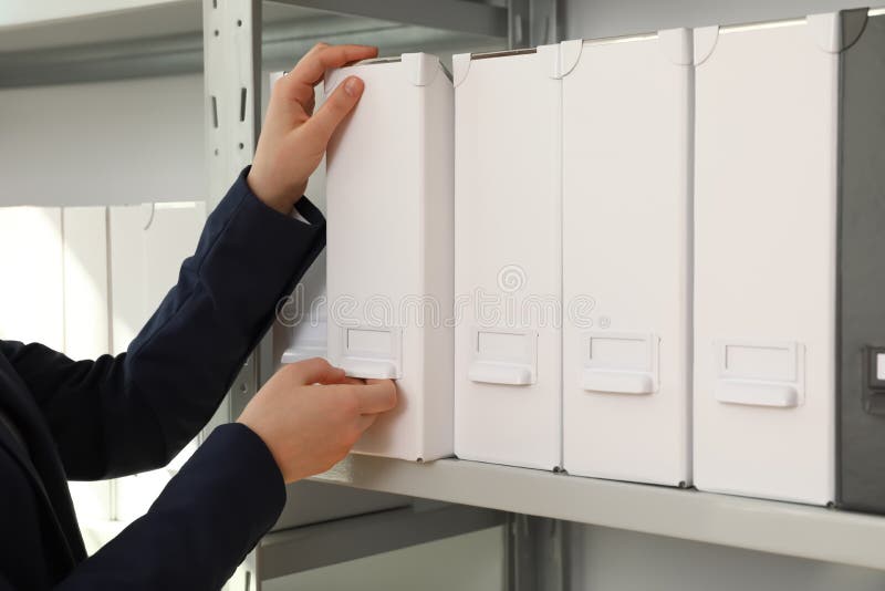 Woman Taking Folder with Documents from Shelf in Archive Stock Image ...