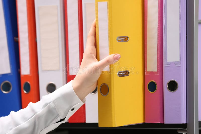 Woman Taking Folder with Documents from Shelf in Office, Closeup Stock ...