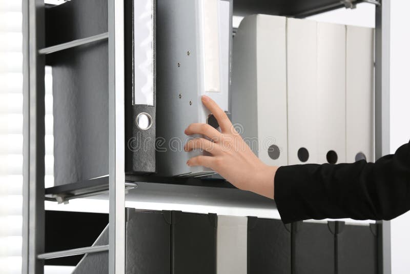 Woman Taking Folder with Documents from Shelf in Office, Closeup Stock ...