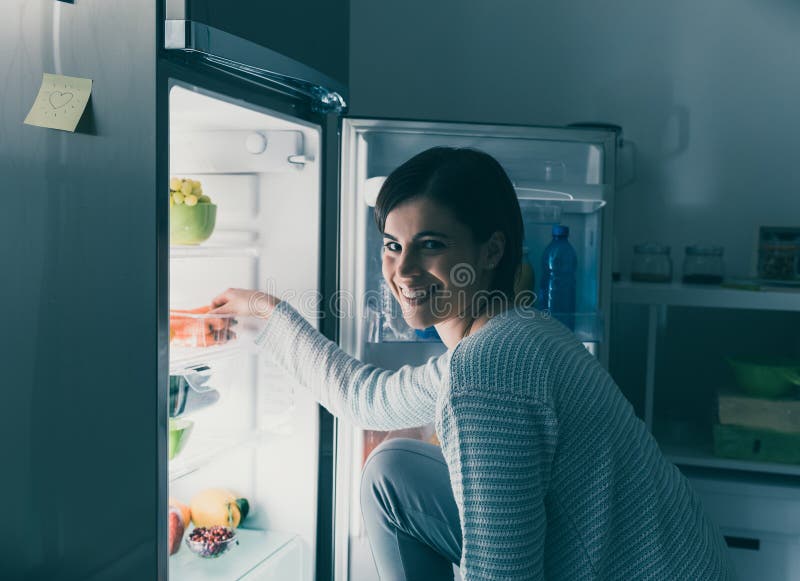 Woman Taking Food Out of the Fridge Stock Photo - Image of food ...