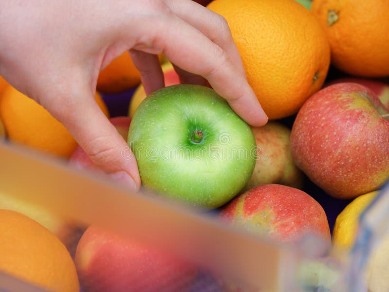 A Woman Taking a Green Apple Out of a Fridge Compartment Stock Image ...