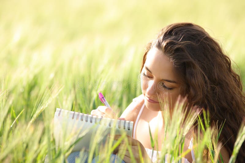 Woman Taking Notes or Drawing on Notebook in a Field Stock Image ...