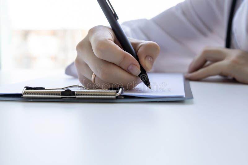 A Woman is Taking Notes. Hand of University Student Using Pen and ...