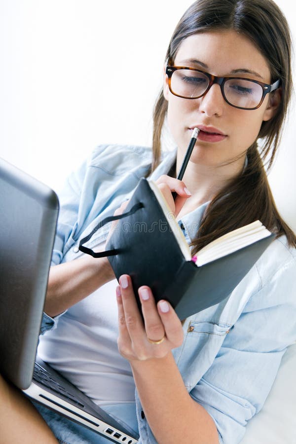 Woman taking notes at home stock photo. Image of student - 32336136