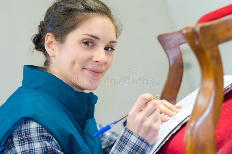 Woman Taking Notes while Upholstering Chair in Workshop Stock Image ...