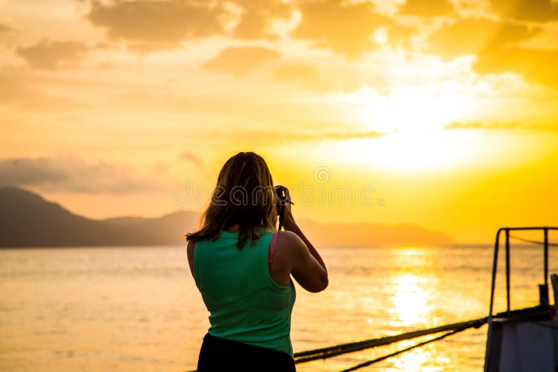 Woman Taking Photos of the Sea at Sunrise Stock Photo - Image of beach ...