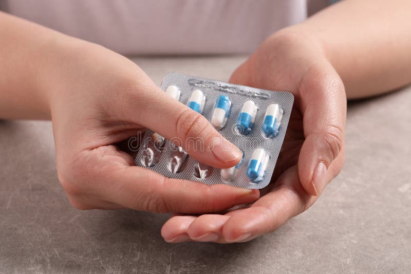Woman Taking Pill Out from Blister Pack at Grey Table, Closeup Stock ...