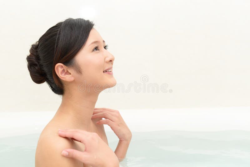 Woman taking relaxing bath stock image. Image of home - 134362023