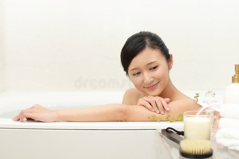 Woman taking relaxing bath stock photo. Image of comfortable - 134361136